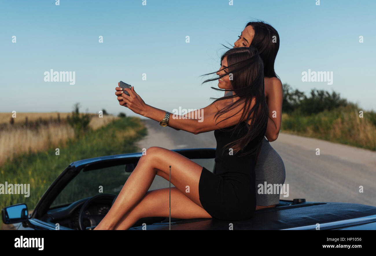 Beautiful two girls are photographed on the road Stock Photo - Alamy