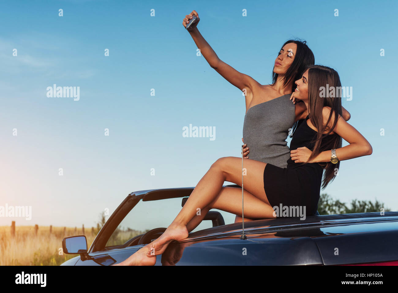 Beautiful two girls are photographed on the road Stock Photo - Alamy