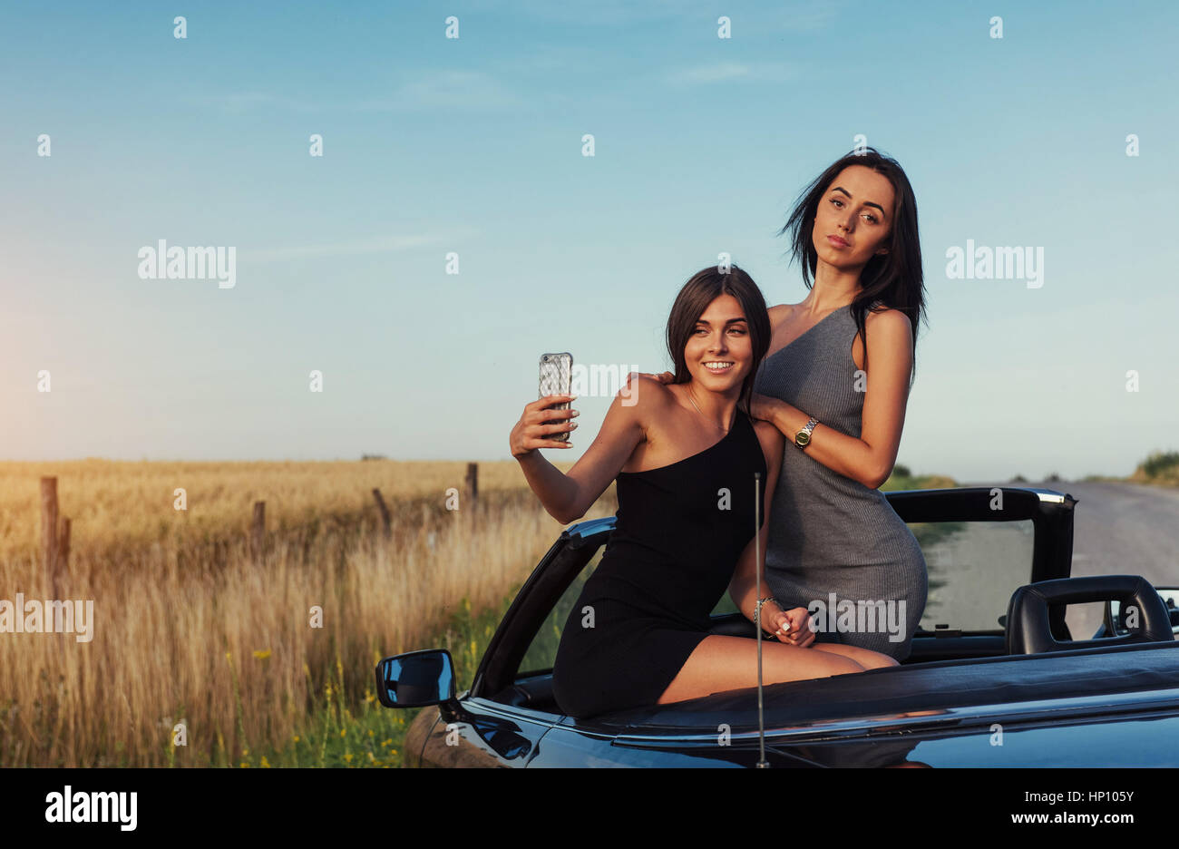 Beautiful two girls are photographed on the road Stock Photo - Alamy