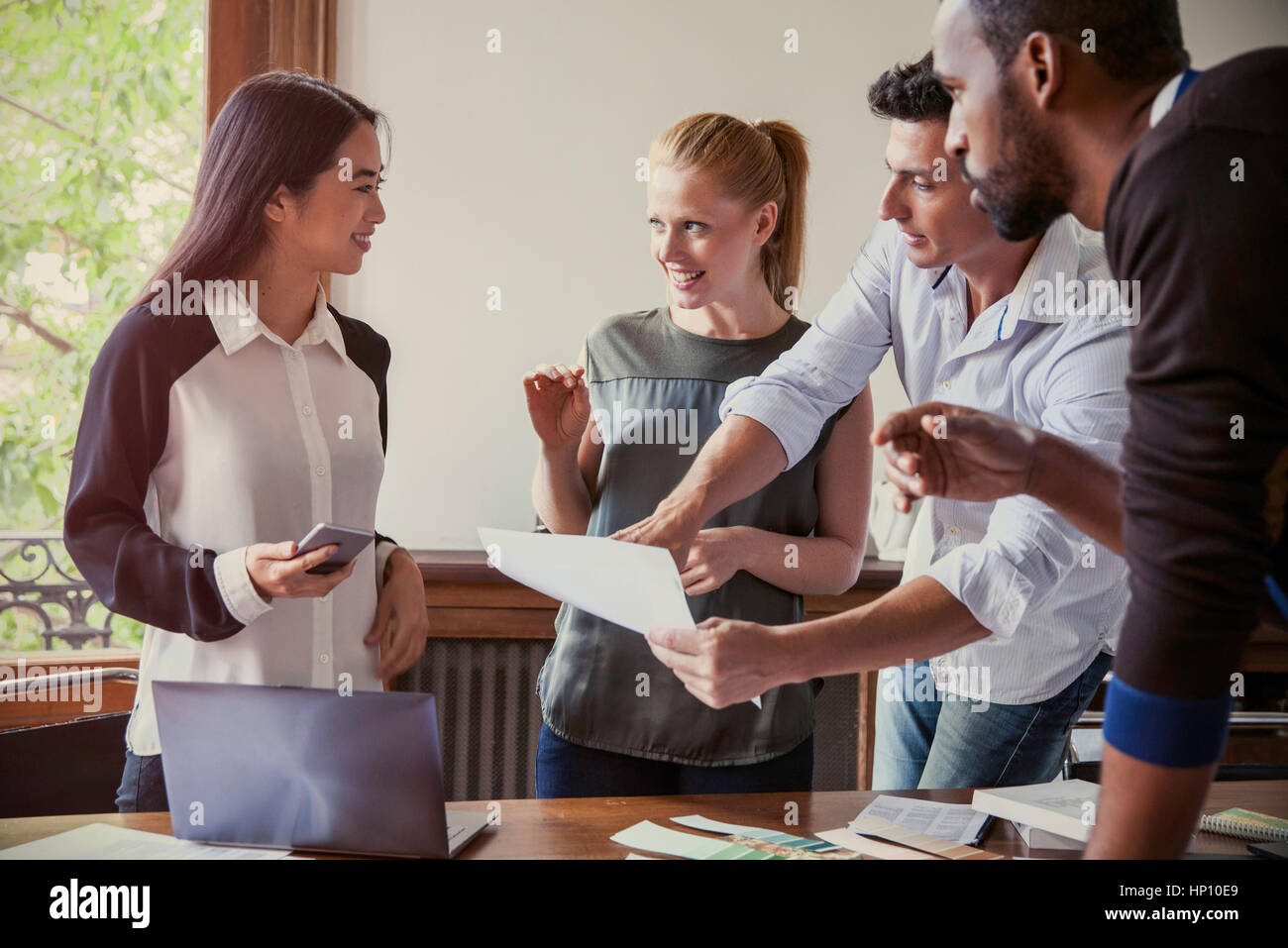 Colleagues collaborating on project in office Stock Photo - Alamy