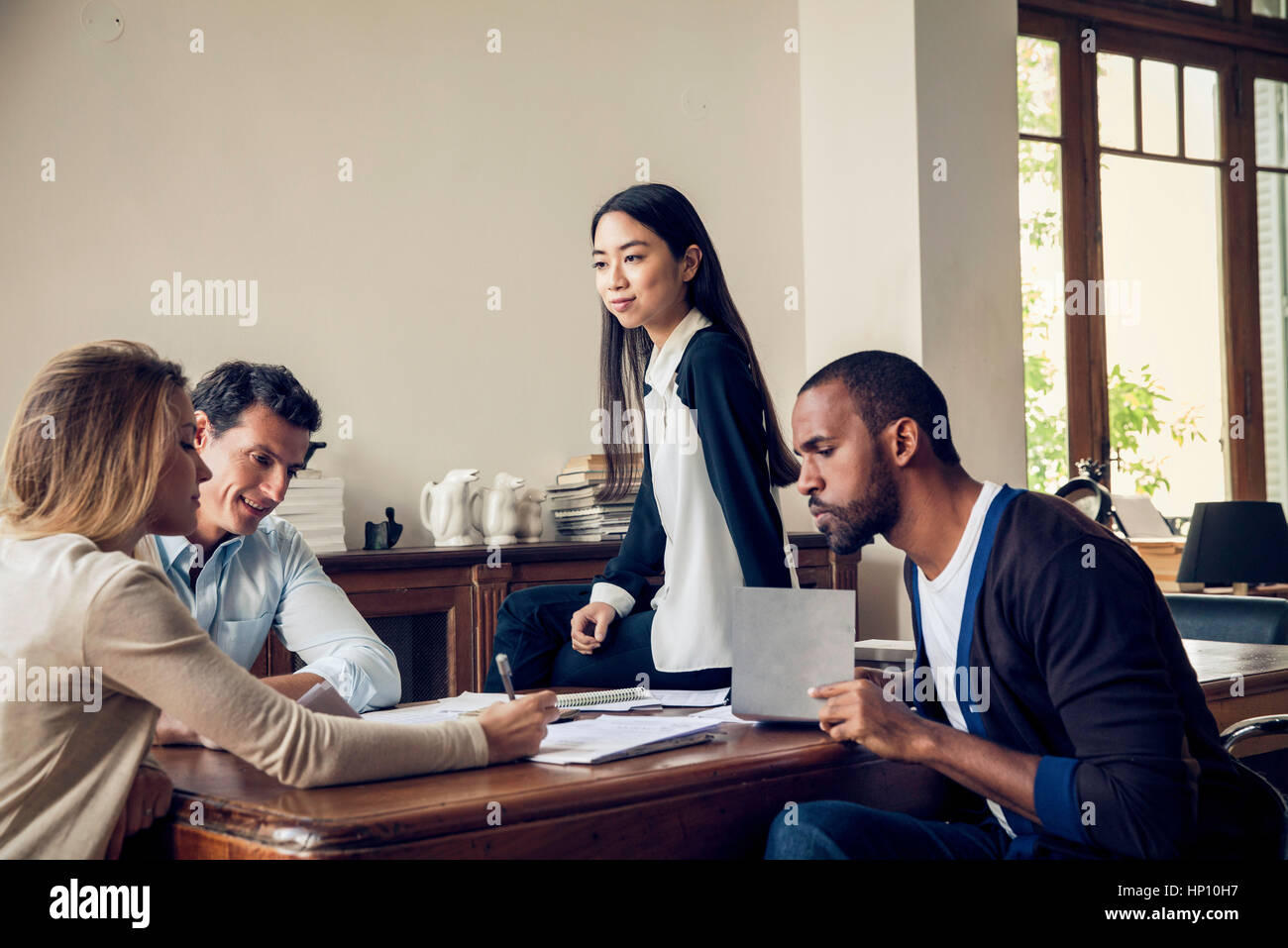 Colleagues working together in casual office Stock Photo - Alamy