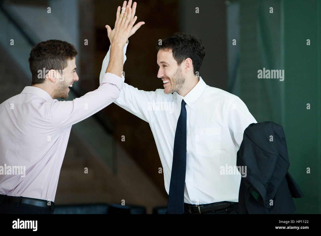 Business colleagues exchanging high five Stock Photo - Alamy