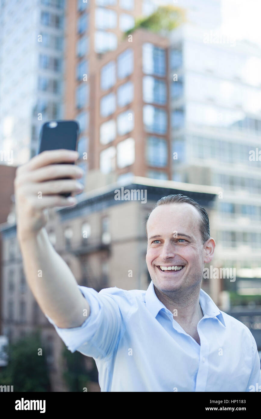 Man using smartphone to take a selfie Stock Photo - Alamy