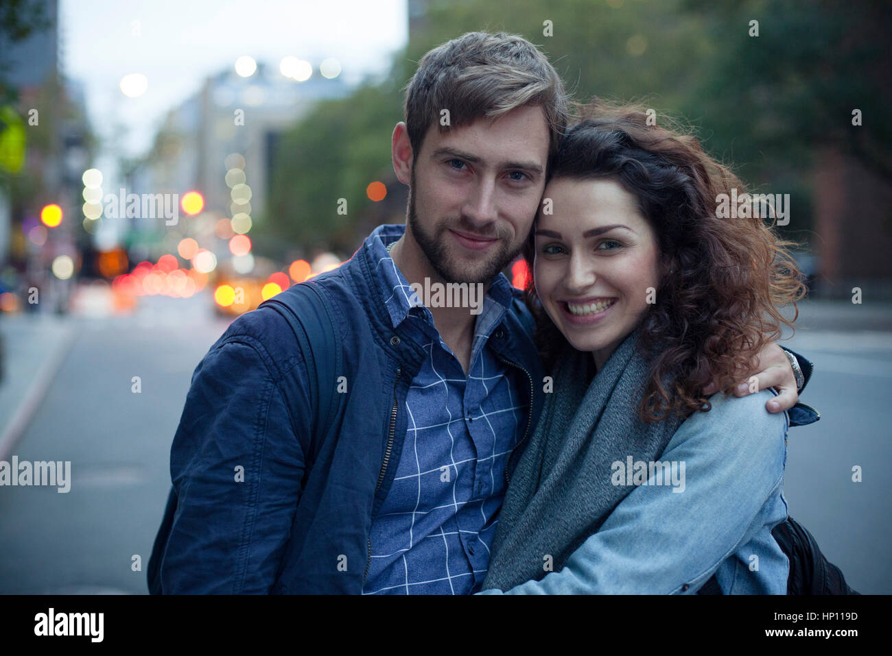 Couple on city street in the evening, portrait Stock Photo - Alamy
