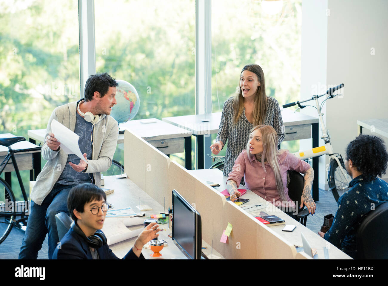 Colleagues interacting in casual office Stock Photo - Alamy