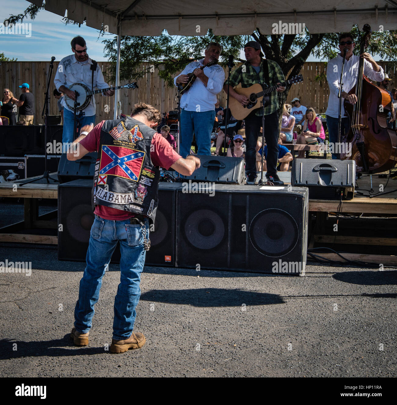Inebriated Redneck conducts musician at beer tasting festival Stock ...
