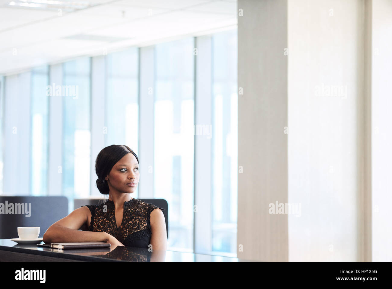 Beautiful young african woman looking thoughtfully off into the ...