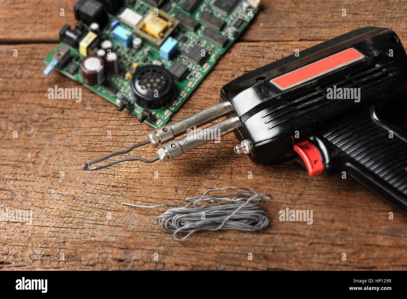 closeup old soldering iron on wooden desk Stock Photo - Alamy