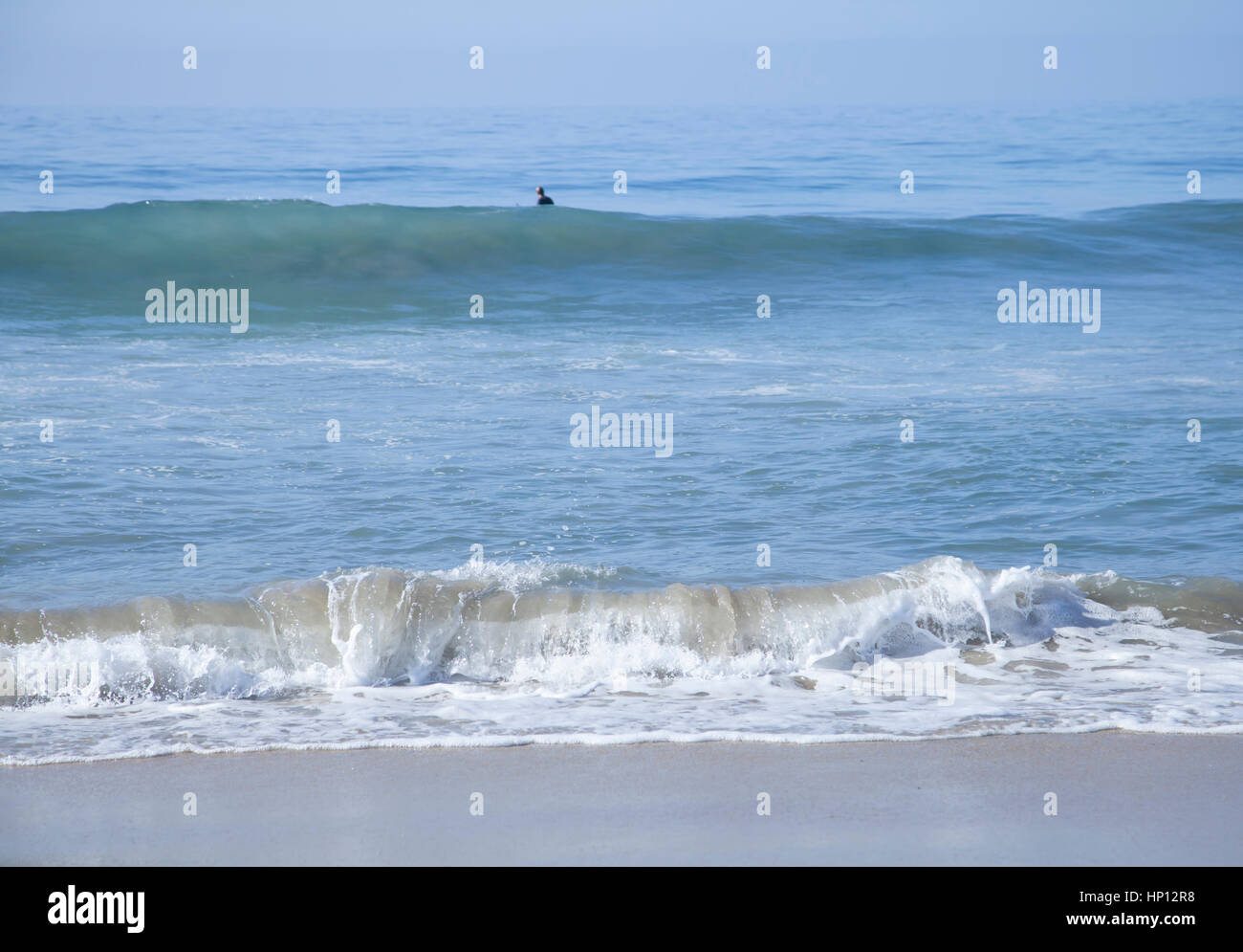 Heavy, foamy waves lapping at the ocean shore Stock Photo - Alamy