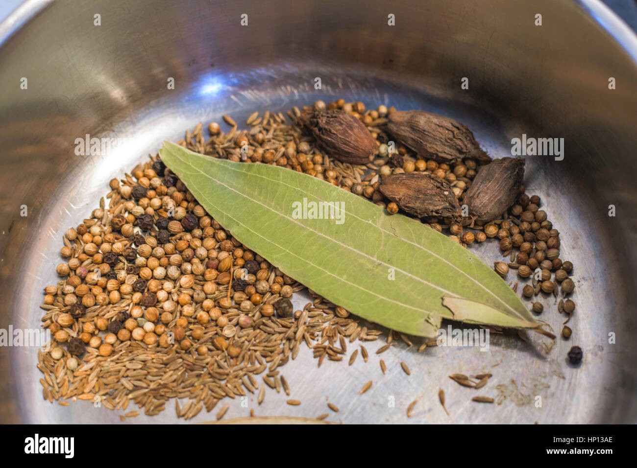 Roasting fresh whole spices in pan Stock Photo - Alamy