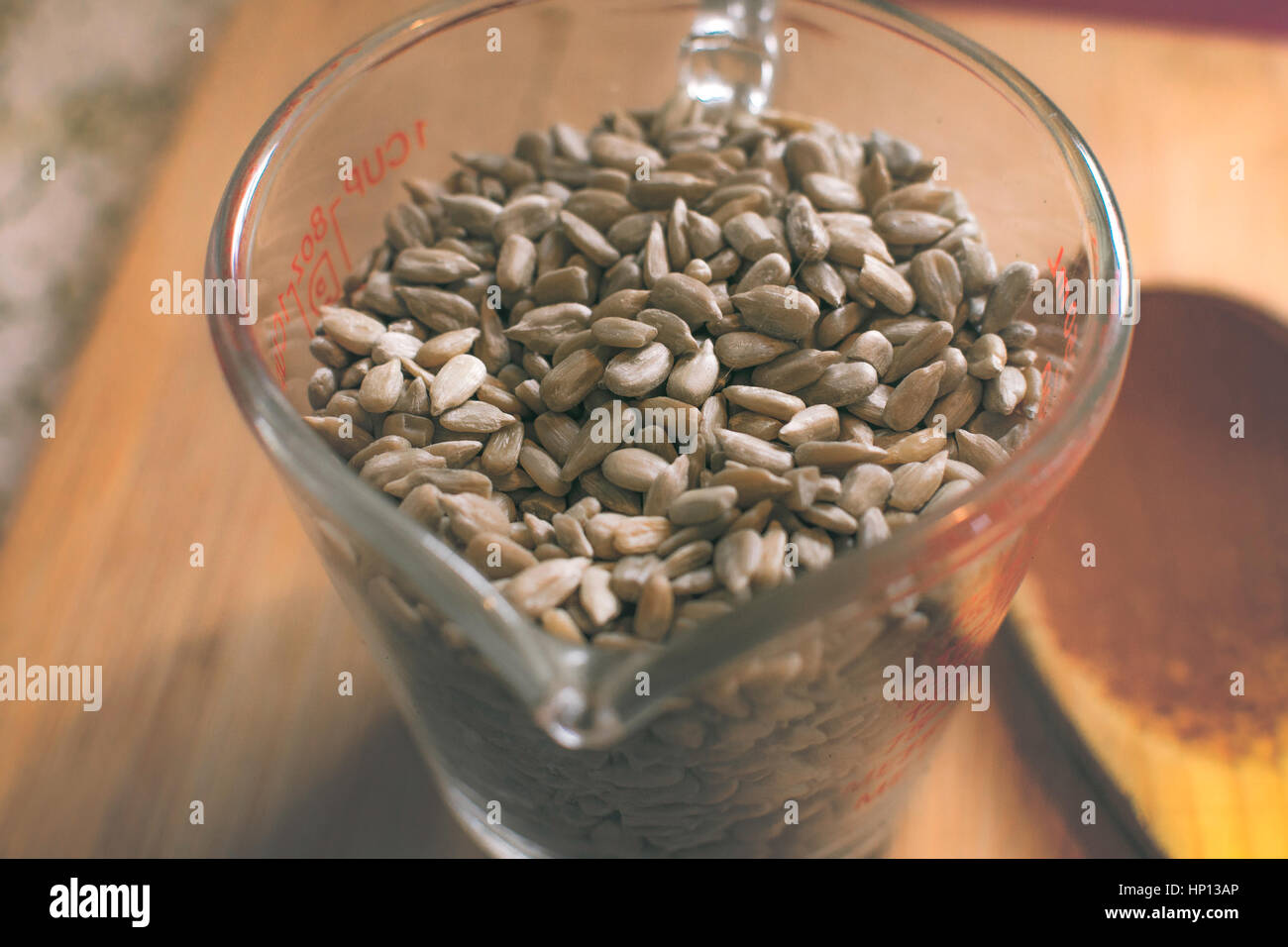 Measuring cup of sunflower seeds Stock Photo - Alamy