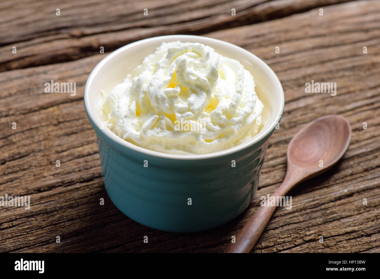 a cup of whipped cream on wooden table Stock Photo - Alamy