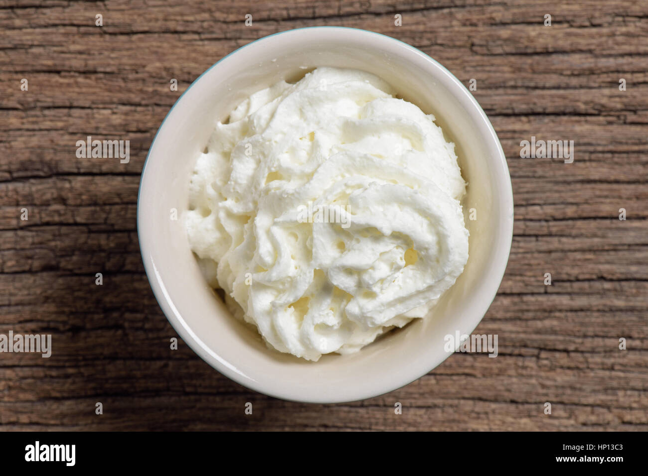 a cup of whipped cream on wooden table Stock Photo - Alamy