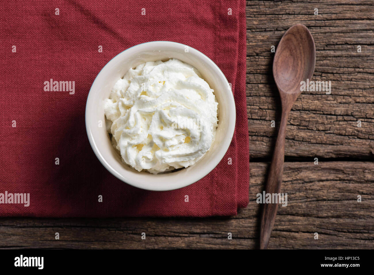 a cup of whipped cream on wooden table Stock Photo - Alamy