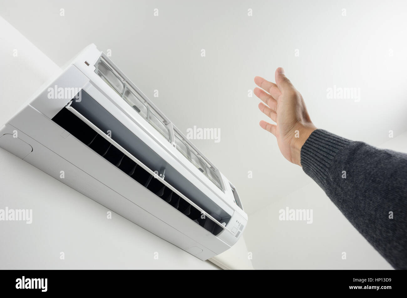 closeup man's hand testing air conditioner in the room Stock Photo - Alamy