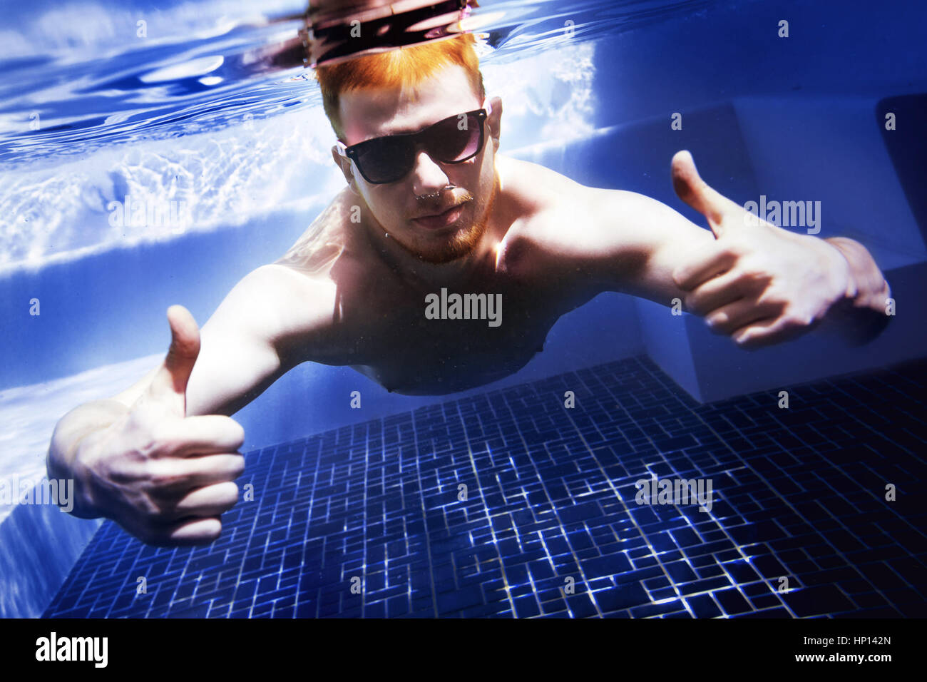 Man underwater swimming pool fun Stock Photo - Alamy