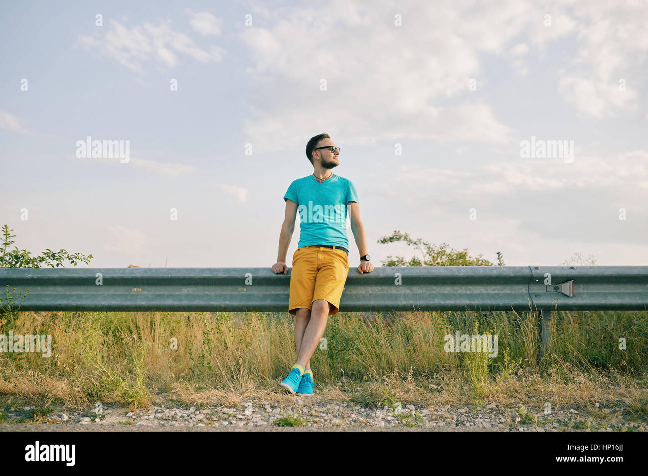 Young man smiling and enjoying sunny summer day Stock Photo - Alamy