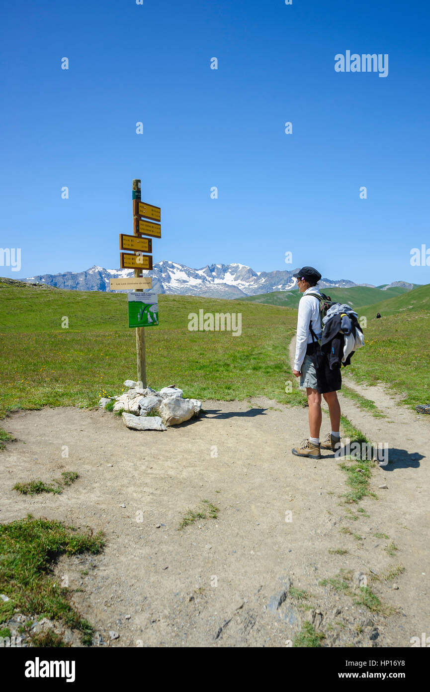 Hiker (woman) looking at direction sign board, France Stock Photo - Alamy