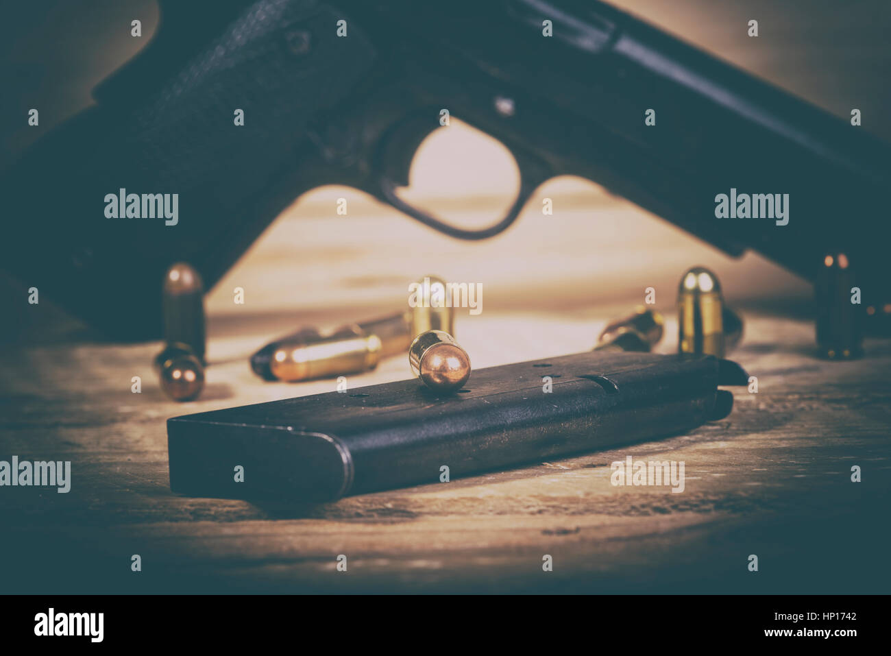 9 mm gun and bullets strewn on the table Stock Photo - Alamy