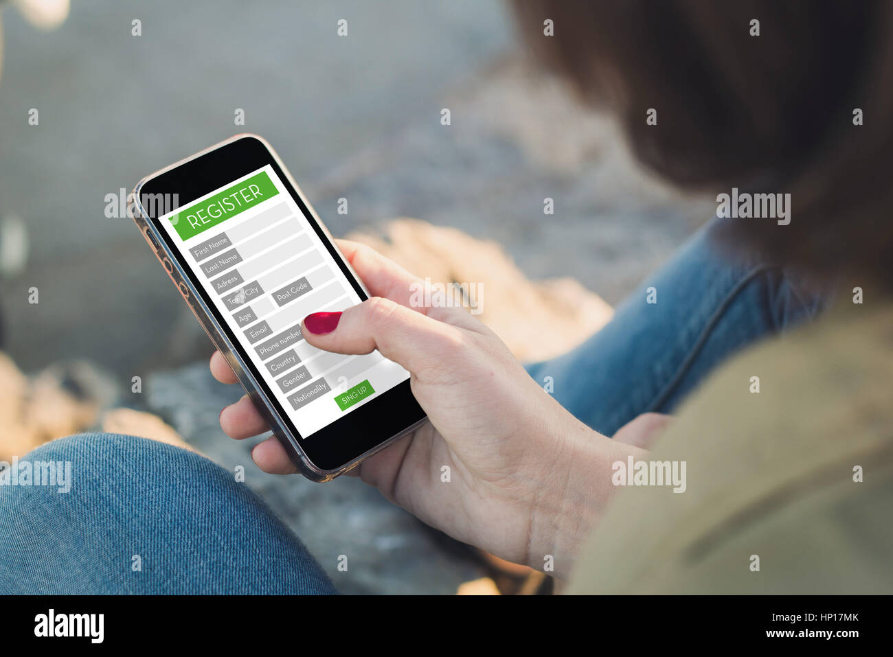 woman using her phone to register on a web. All screen graphics are ...