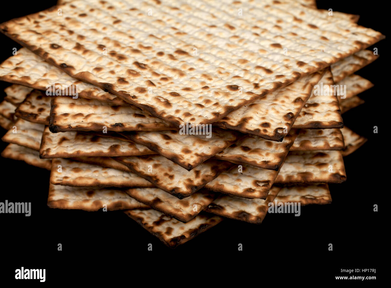 Traditional Jewish matzah on a black background. Close-up Stock Photo ...