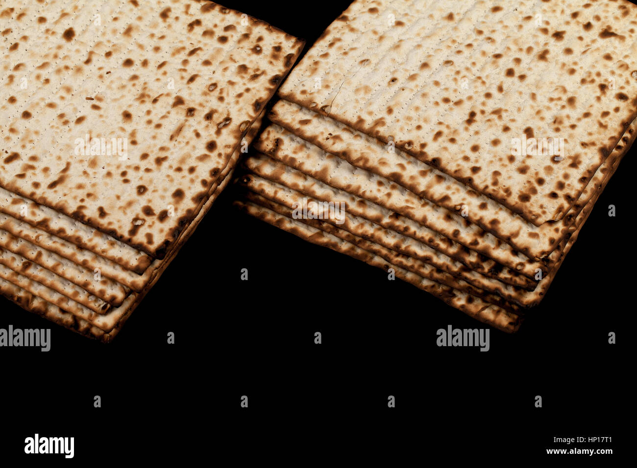 Traditional Jewish matzah on a black background. Close-up Stock Photo ...