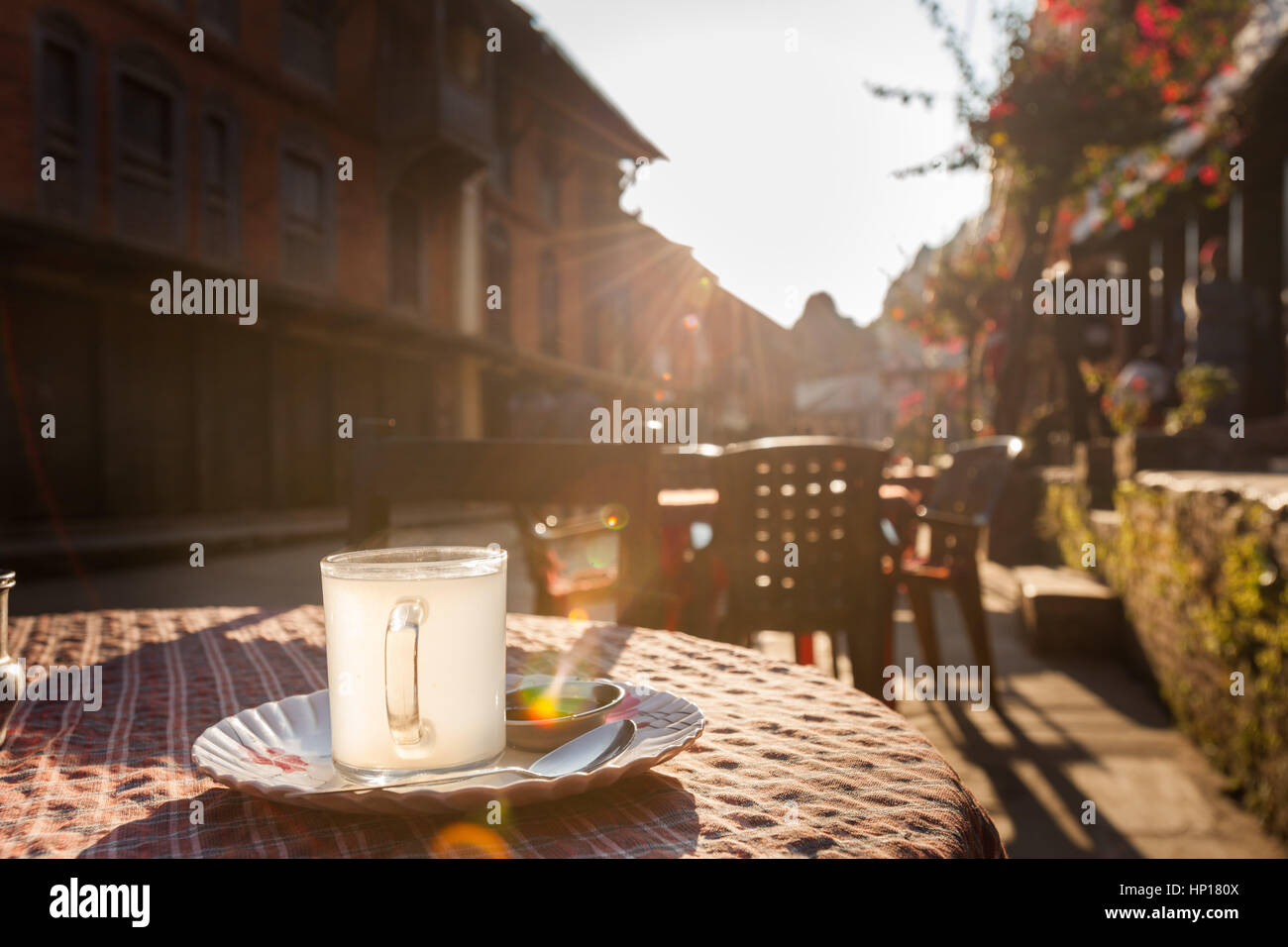 Cup of hot ginger lemon tea with traditional medieval houses, Bandipur ...