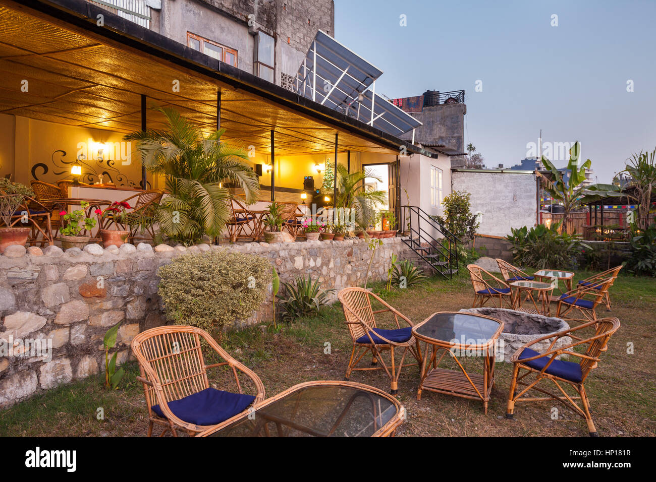 Outdoor cafe tables in the evening next to Phewa (Fewa) Lake in Pokhara ...