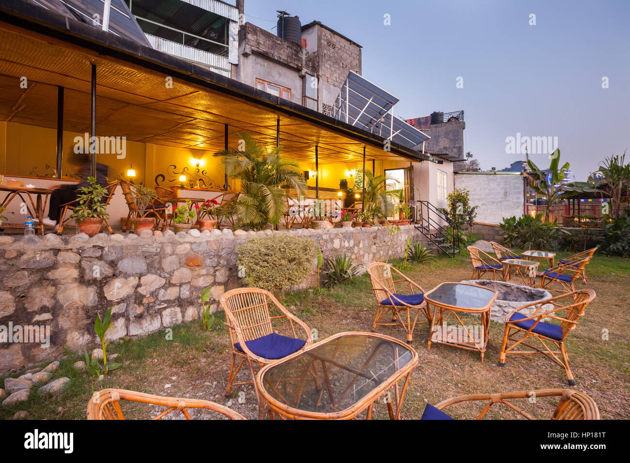 Outdoor cafe tables in the evening next to Phewa (Fewa) Lake in Pokhara ...