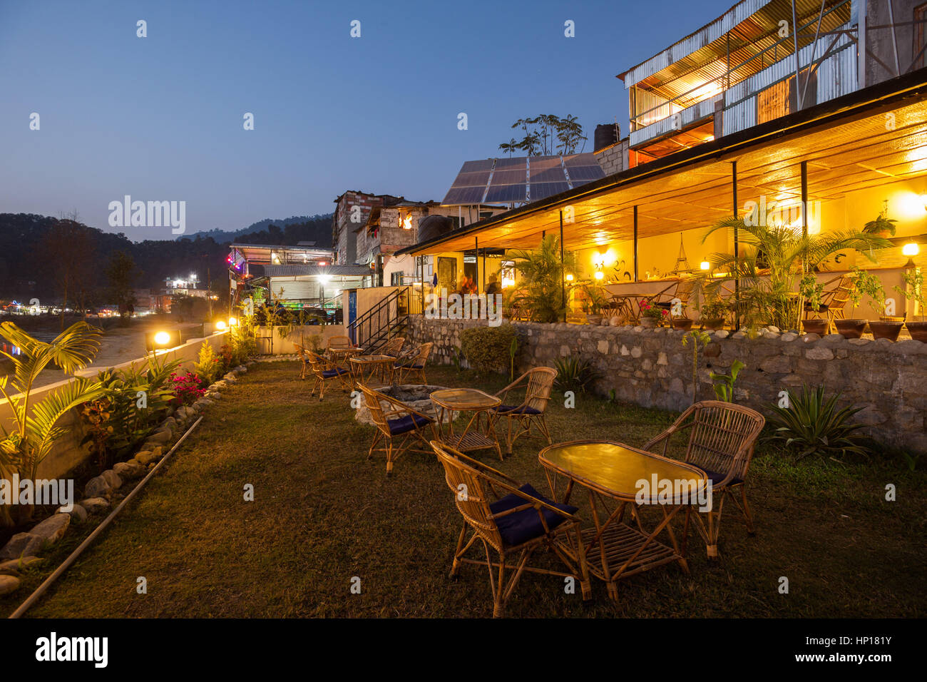 Outdoor cafe tables in the evening next to Phewa (Fewa) Lake in Pokhara ...