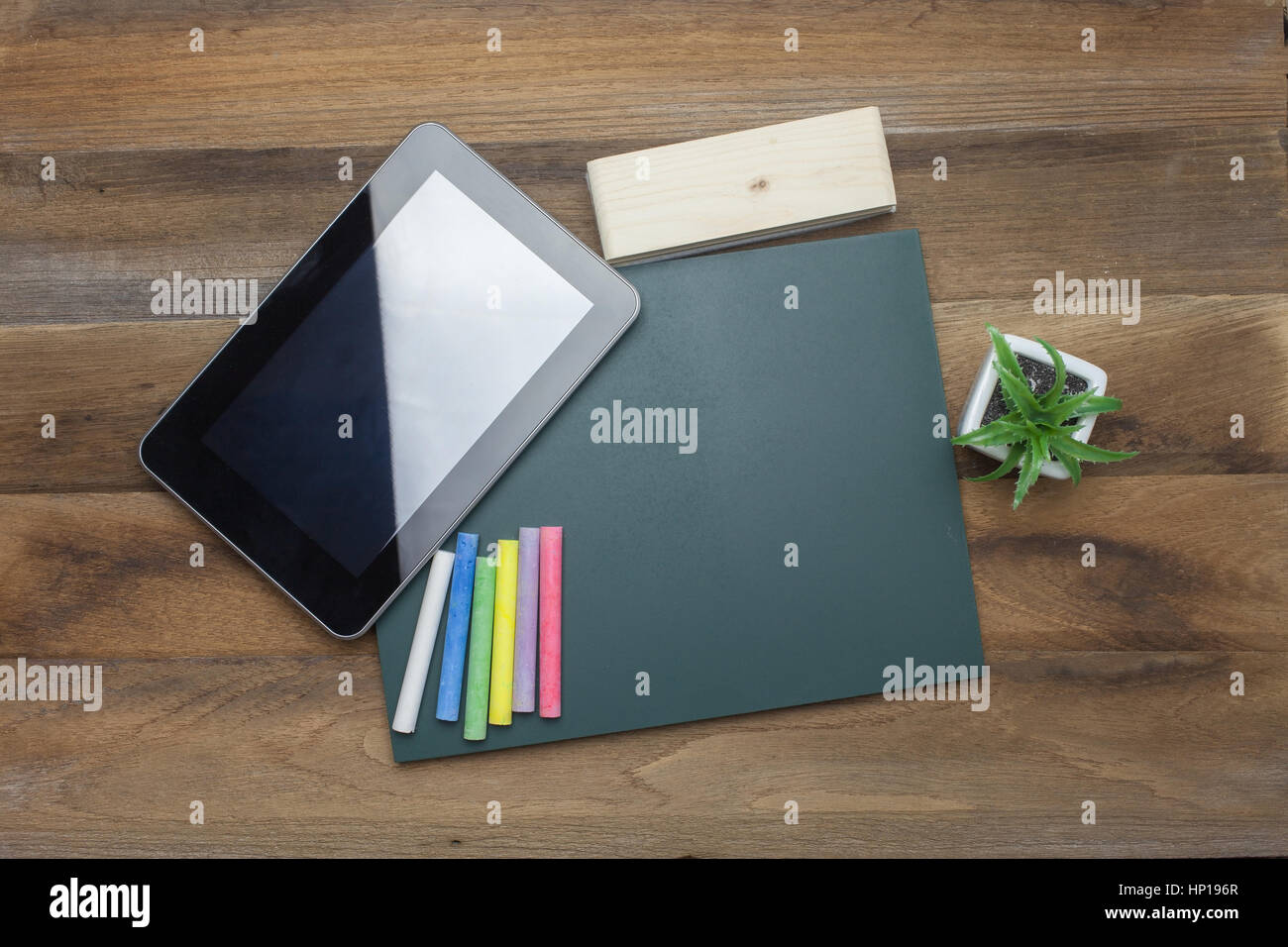 Tablet,Colorful Chalks,Chalk board and eraser on wooden background ...
