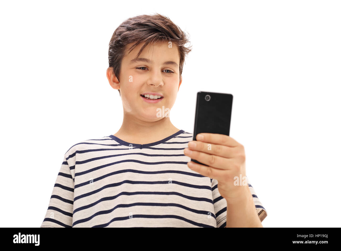 Boy looking at a phone and smiling isolated on white background Stock ...
