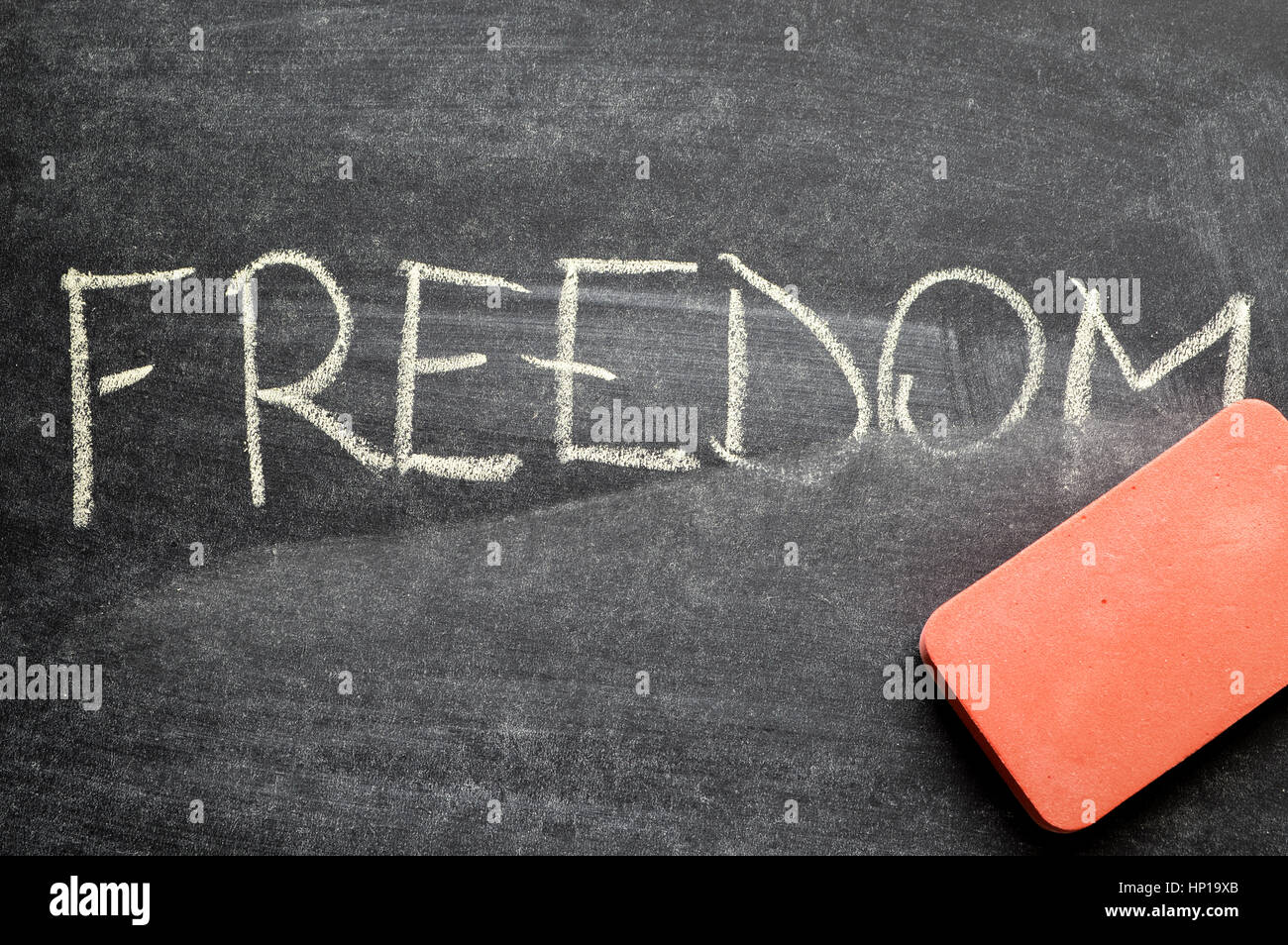 erasing freedom, hand written word on blackboard being erased concept ...
