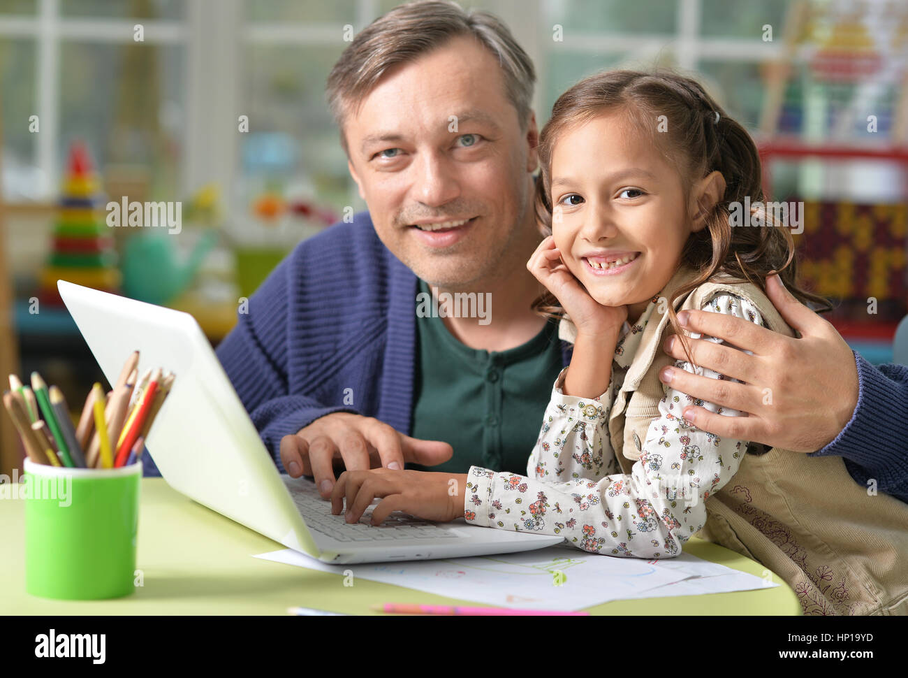 Father and daughter using laptop Stock Photo - Alamy