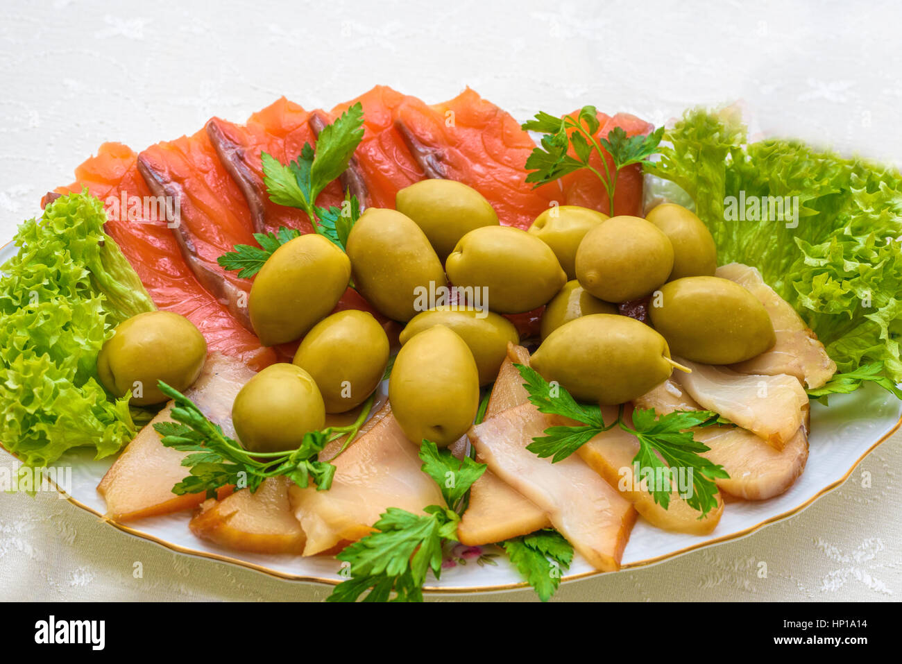 Smoked salmon and fish with olives appetizer. Russian cuisine snack ...