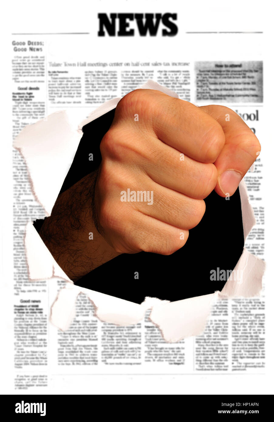 male fist ripping into a newspaper, breaking news concept Stock Photo ...