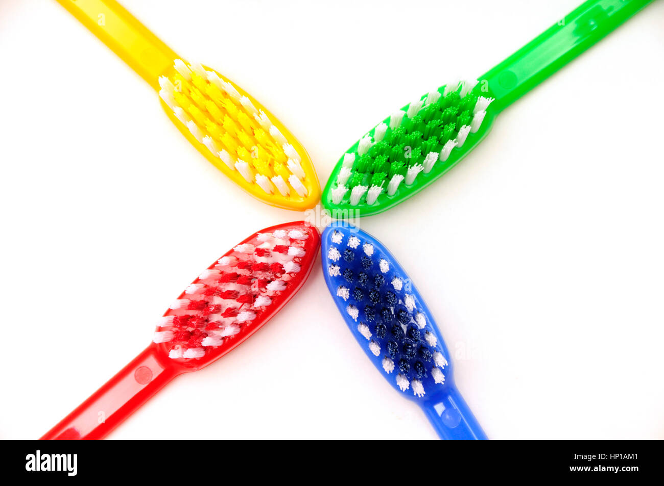 four colorful toothbrushes isolated Stock Photo - Alamy