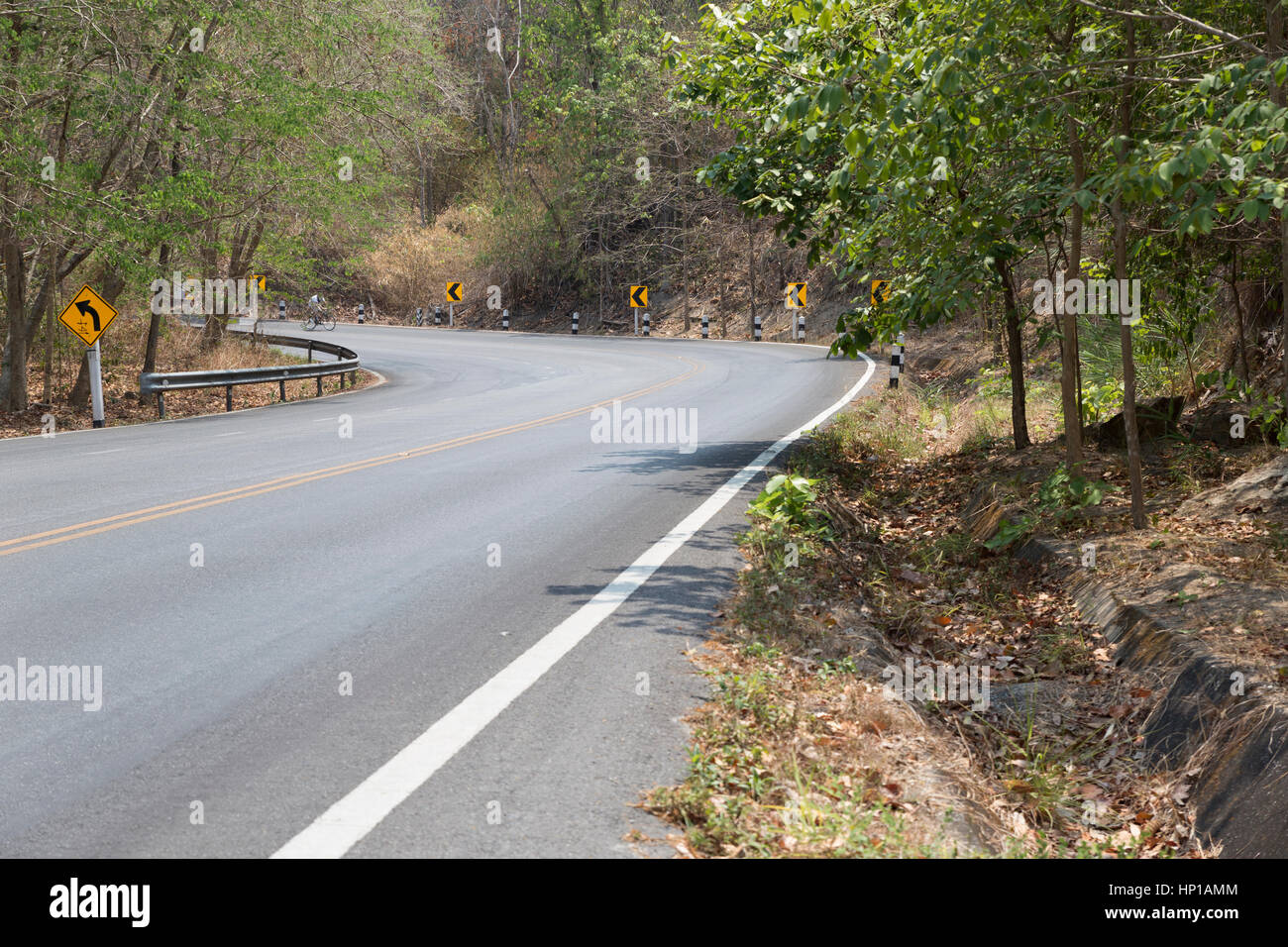 curve of road on mountain hill in forest Stock Photo - Alamy
