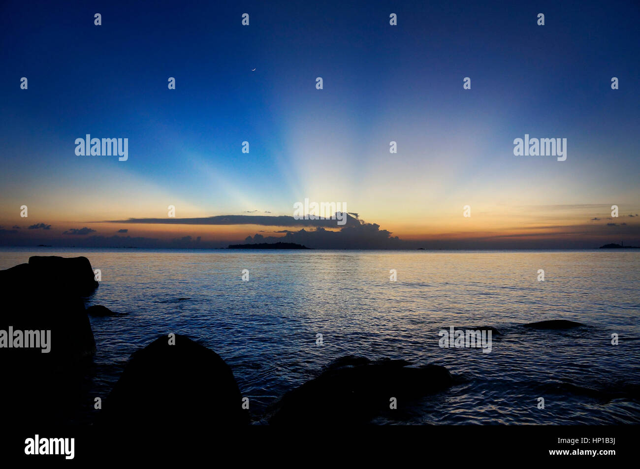 Watching and enjoying the sun rays as the sun is setting Stock Photo ...