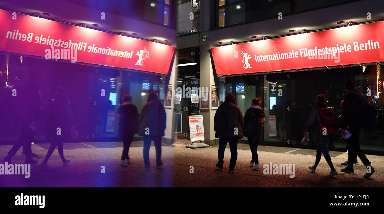 Pedestrians walk past a banner advertising the 67th Berlinale Film ...
