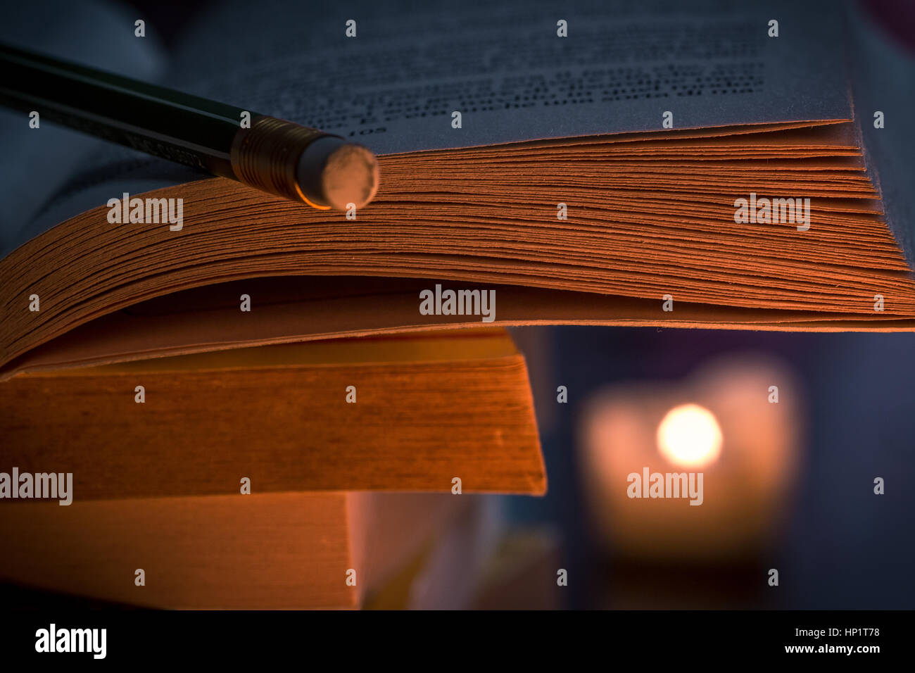 stack of books in the light of the candle Stock Photo - Alamy