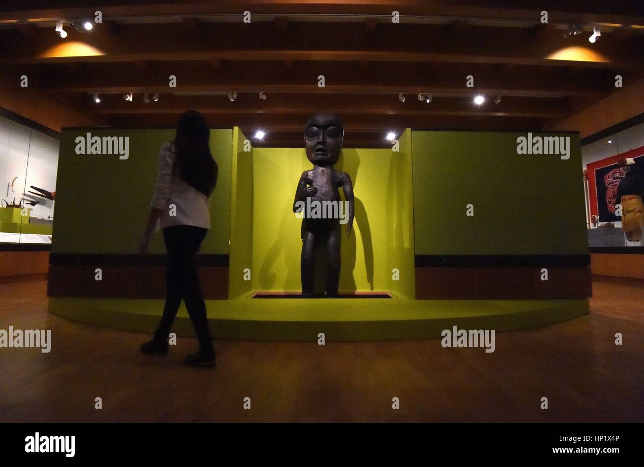 A person walks past a 7.6 ft, 19th century Welcome Figure is installed ...