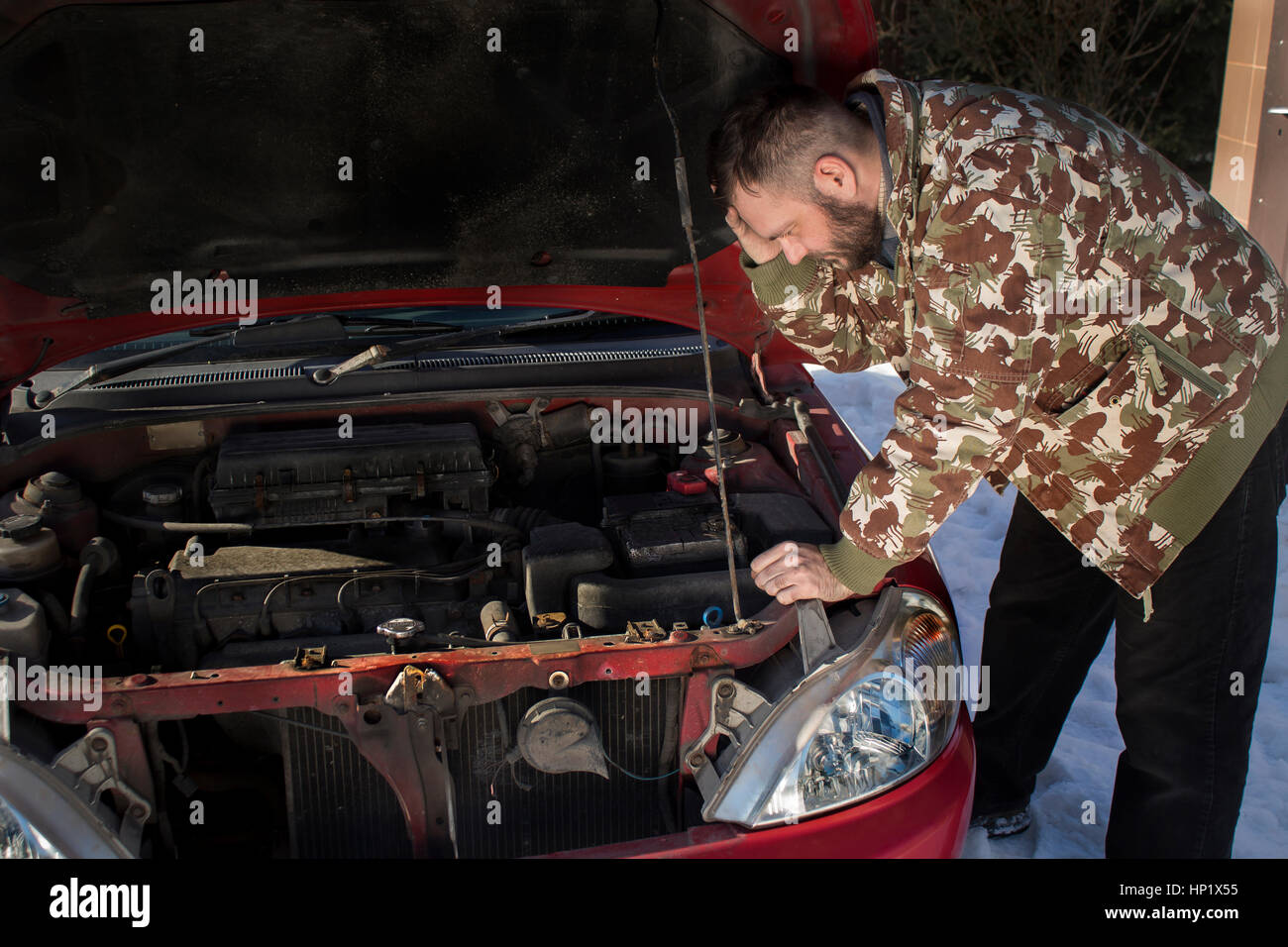 Mechanic wonders what went wrong in the car. Helpless man looks at the ...