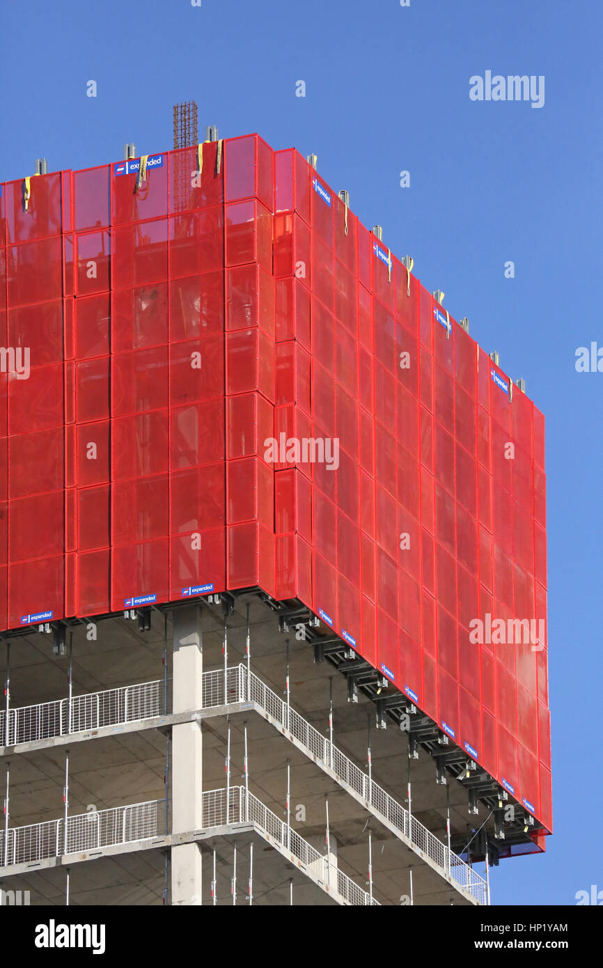 Climbing, protective screens surround the top of a new, concrete framed ...