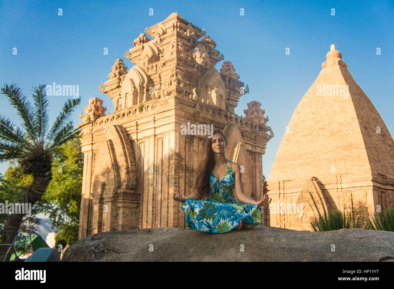 beautiful girl sitting in the lotus position on the stone Stock Photo ...
