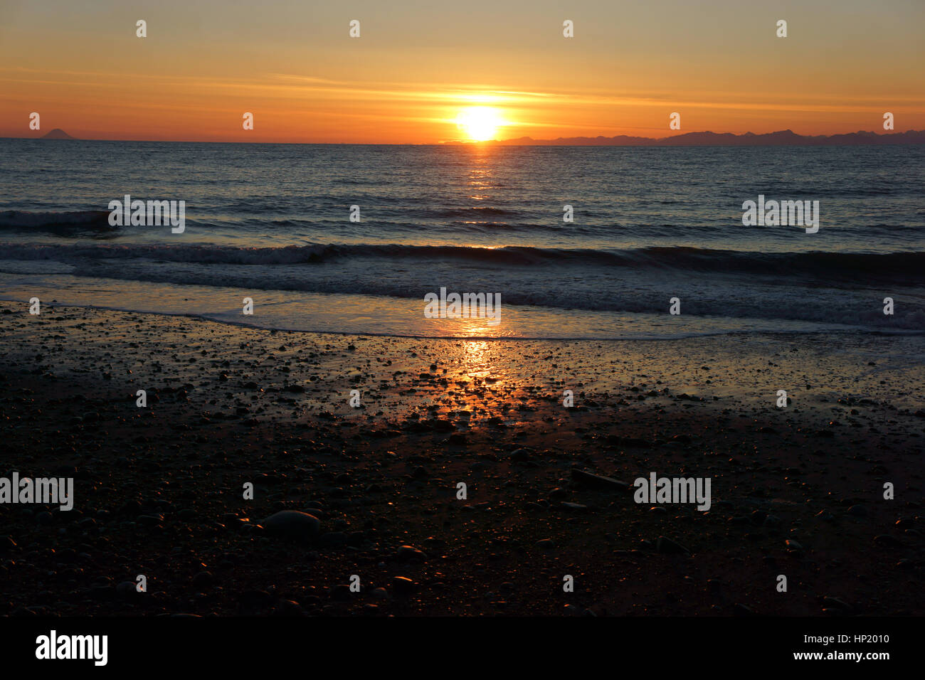 Sunset on lower Cook Inlet seen from Homer Spit with Augustine volcano ...