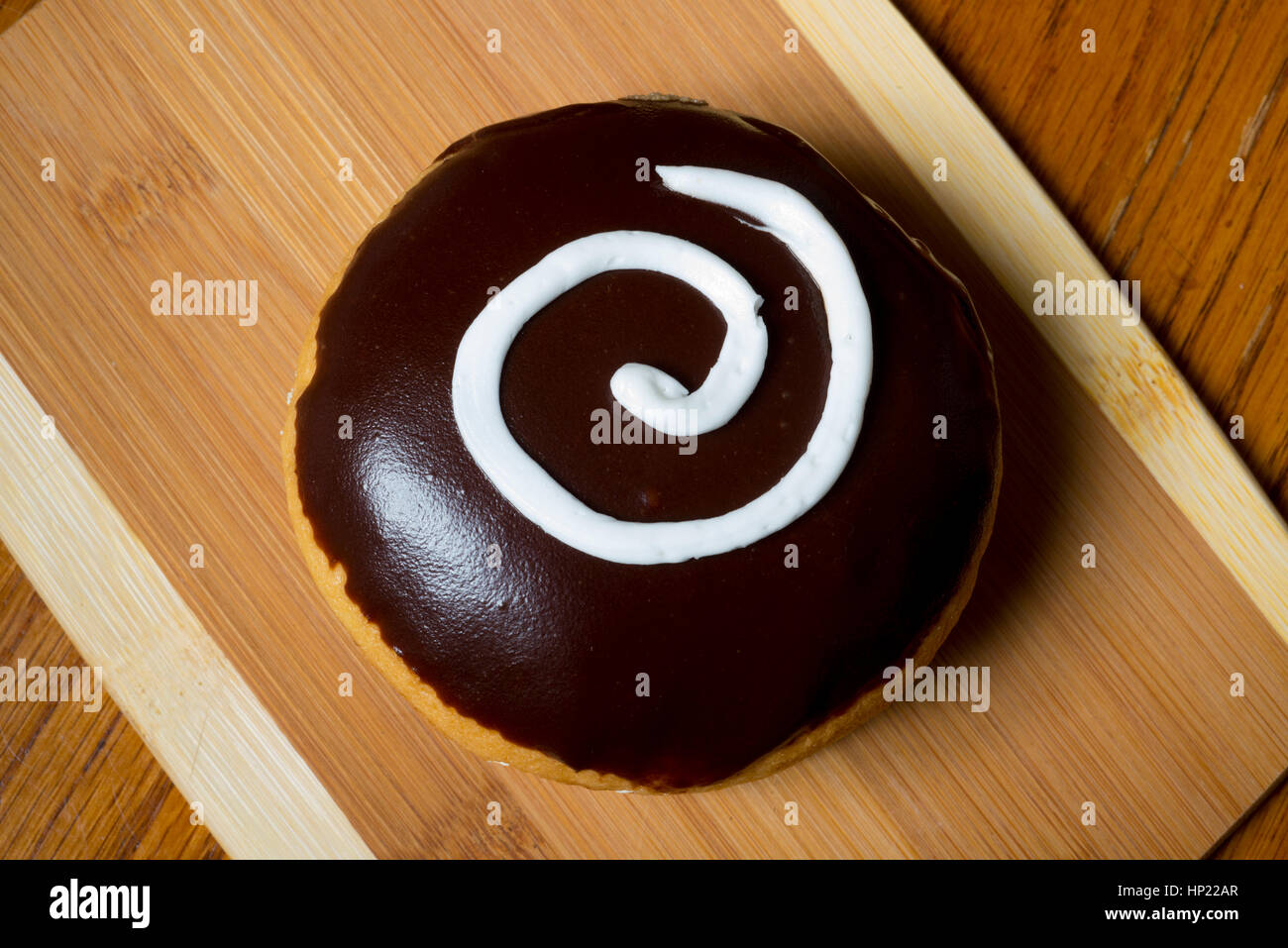 round chocolate eclair over top with white swirl Stock Photo - Alamy