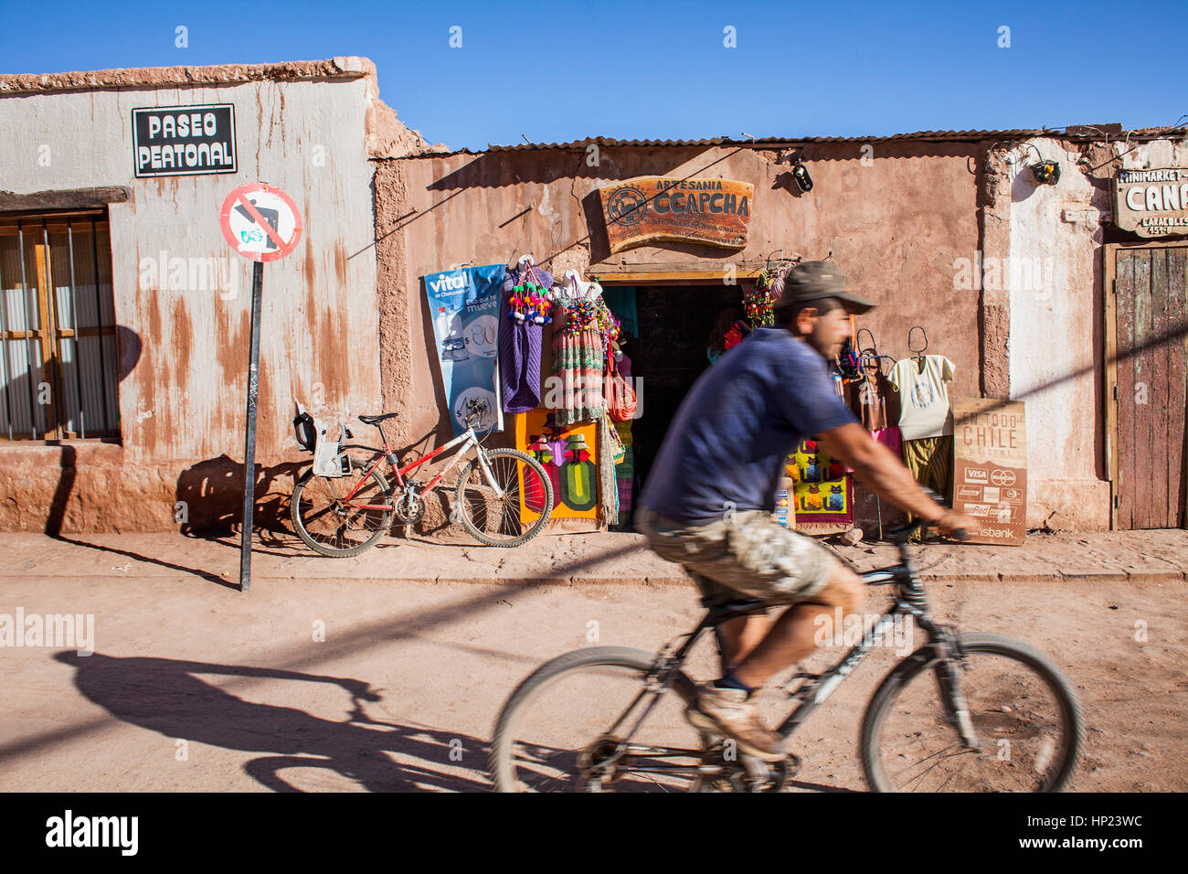 Man biking, cycle, Caracoles street, San Pedro de atacama village ...