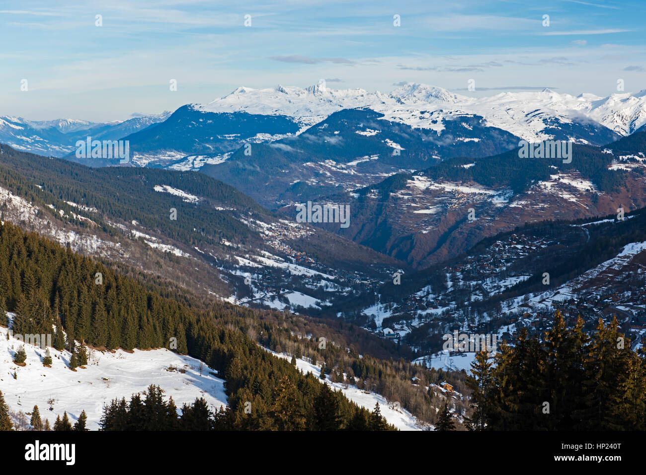 Panoramic view down snow covered valley in alpine mountain range with ...