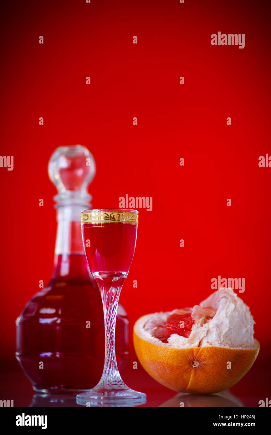 sweet grapefruit alcoholic cordial in the decanter with a glass Stock ...